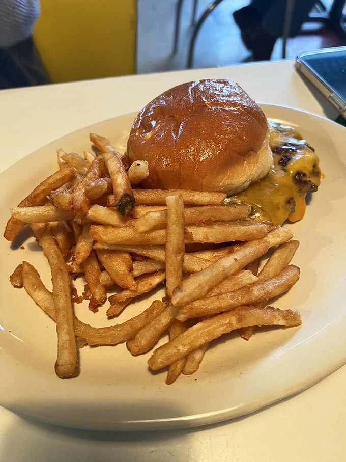 The cheeseburger and fries combo that proves The Cracker Box isn't just a one-trick breakfast pony—it's an all-day flavor festival.
