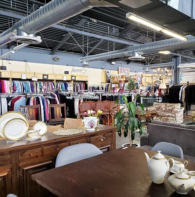 The clothing section mingles with furniture in a dance of decades—that teapot might have served tea to someone wearing that very dress.
