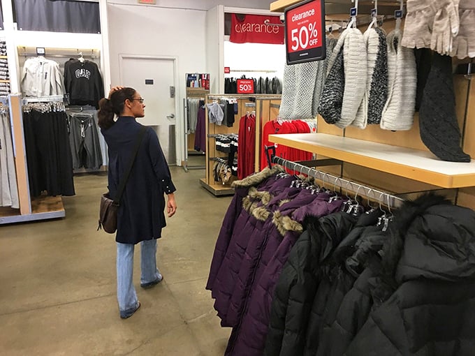 A shopper contemplates winter coats in Alabama—an optimistic purchase given the state's brief acquaintance with actual winter temperatures.