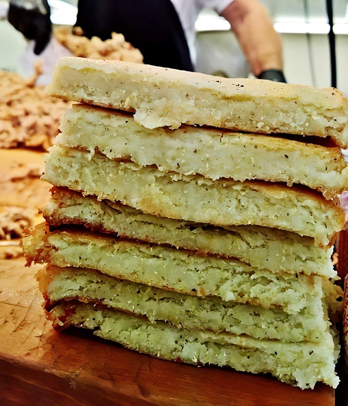 Cornbread stacked like gold bars at Fort Knox. Dense, substantial, and worth its weight in culinary currency—the perfect sauce-sopping companion.