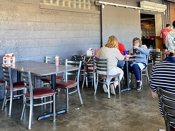 The concrete floors and metal chairs might say "no frills," but the diners' expressions tell the real story: meat-induced happiness.