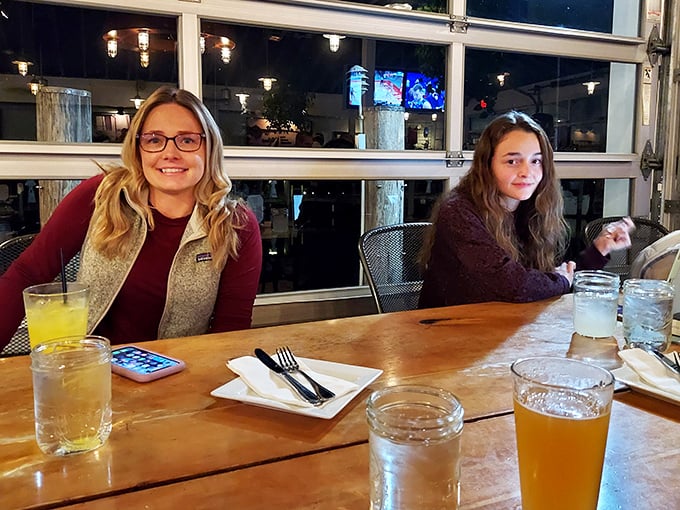 Happy diners enjoying drinks with a view. When the food arrives, those smiles will only get bigger—seafood has that effect on people.