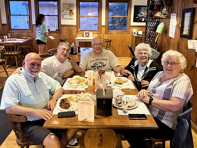 Happy diners sharing a meal and memories—this is what Ray's is really about. Good food brings good people together around sturdy wooden tables.