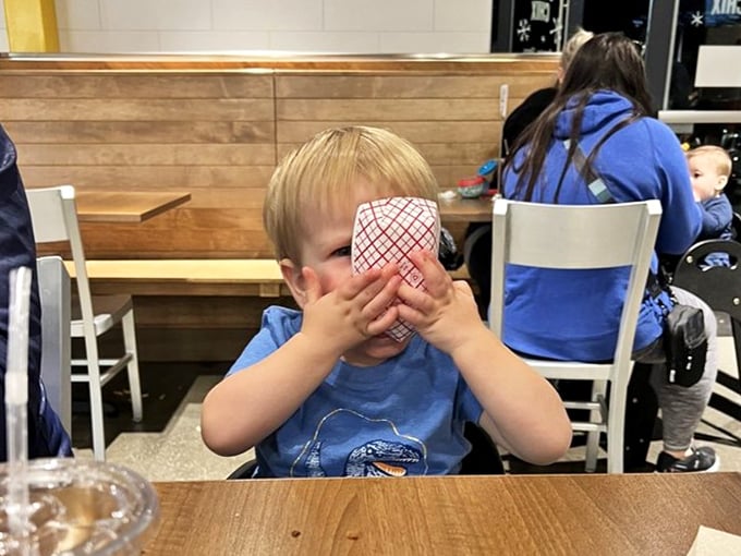 Even the youngest food critics approve—this little connoisseur is clearly having a religious experience with whatever's behind those hands.