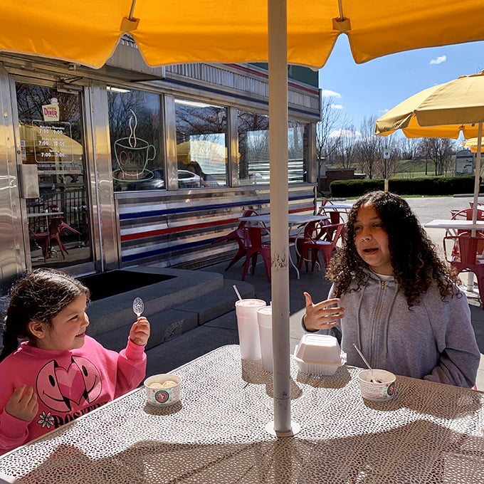 Two young diners enjoying the outdoor seating – creating memories that will have them seeking out chrome-sided eateries for the rest of their lives.