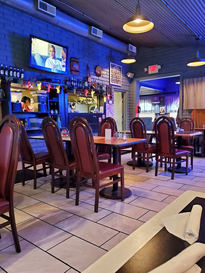 The evening ambiance brings a cool blue glow to the dining room, where sports on TV and good food create community.