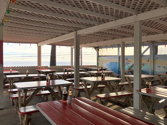 Empty tables waiting for the lunch rush—a rare sight. Early birds get more than worms here; they get unobstructed ocean views with their fish.