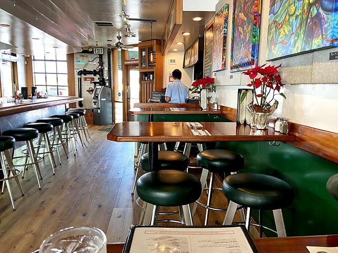 The bar area combines warm wood tones with nautical touches – the perfect spot to contemplate your next seafood selection.