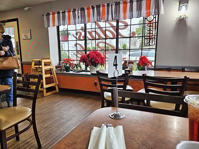 Window seats at Ida's—where poinsettias add festive cheer and you can people-watch while debating between sweet or savory for your next visit.