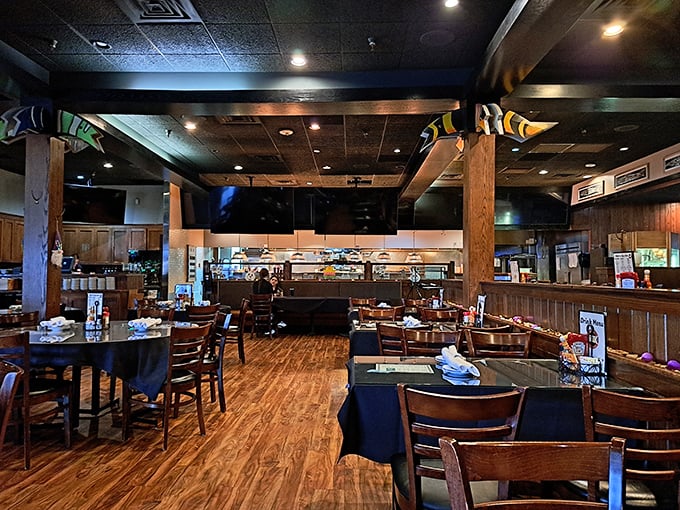 Wooden beams, colorful fish sculptures overhead—the dining room balances nautical touches with Midwestern warmth in perfect harmony.