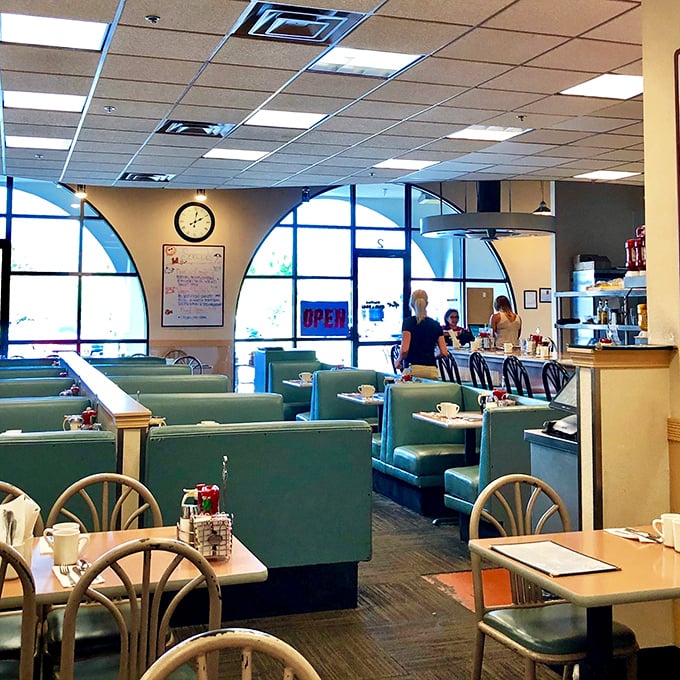 The dining area balances retro charm with modern comfort—those teal booths have witnessed countless first dates, family reunions, and hangover recoveries.