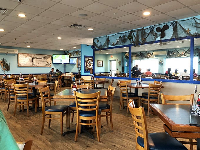 The dining room hums with conversation and clinking glasses, while nautical décor reminds you that your dinner probably swam nearby.