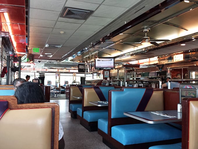 Classic diner booths in that perfect shade of blue – where important life decisions are made over bottomless cups of coffee.
