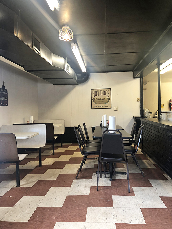 No-frills dining at its finest—just clean tables, sturdy chairs, and a hot dog sign that promises simple pleasures done right.