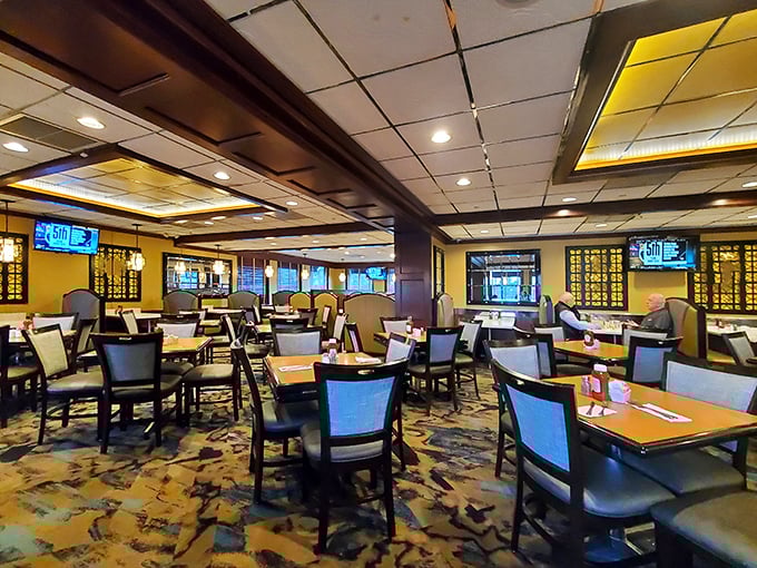 The dining room – where strangers become neighbors over plates of pancakes. Modern lighting casts a warm glow over conversations and comfort food.