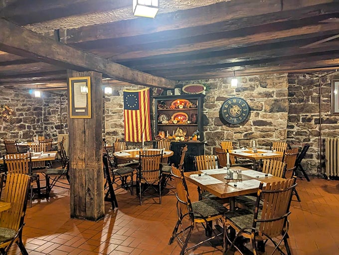 Stone walls and wooden beams create a dining space where you can almost hear the whispers of Revolutionary-era patrons plotting over their pot pies.