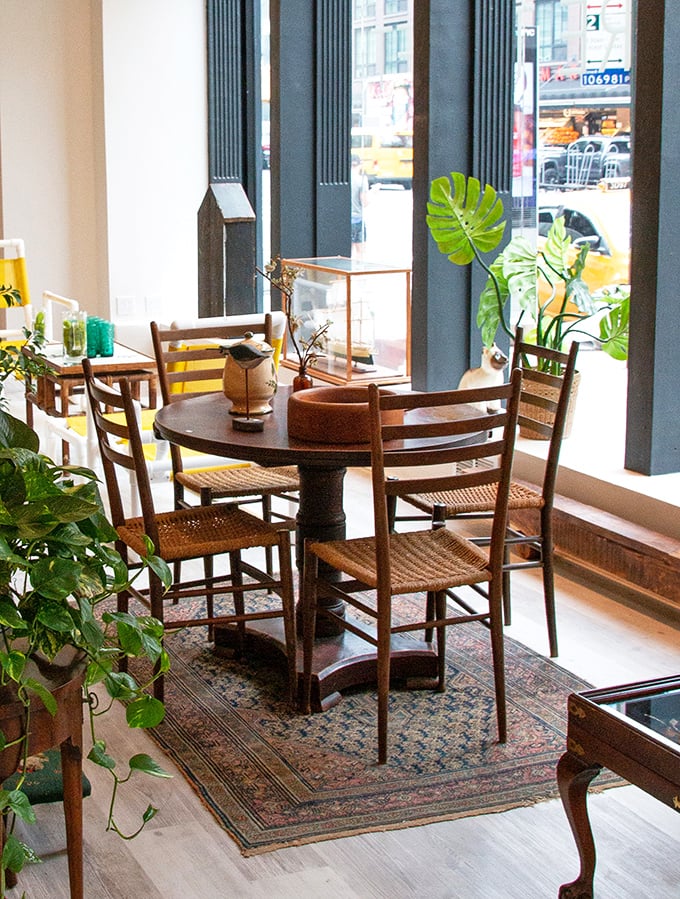 This isn't just a dining set—it's a time machine to dinner parties past, complete with cane chairs and a perfectly worn wooden table.