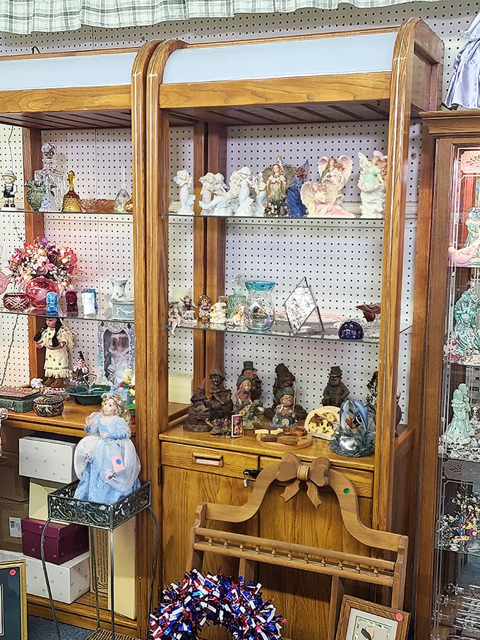 This oak display cabinet houses a miniature world of collectible figurines, where porcelain angels and carved gnomes coexist in delicate harmony.