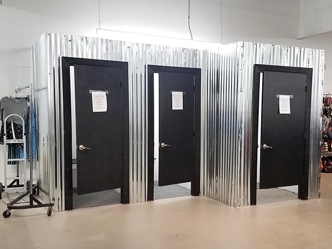 Fitting rooms with industrial chic flair. What happens behind these corrugated metal doors? Fashion magic or reality checks—sometimes both!