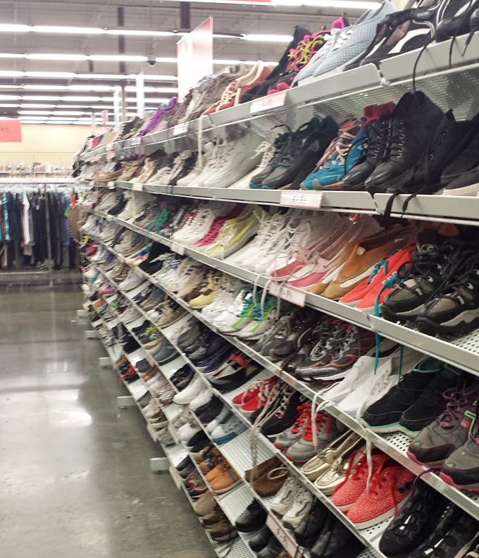 The shoe wall—a footwear fantasy where hiking boots that have summited mountains sit beside pristine pumps that never left the closet.