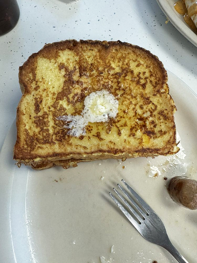 French toast that's achieved the impossible balance—crispy edges, custardy center, and enough butter to make Julia Child smile from above.