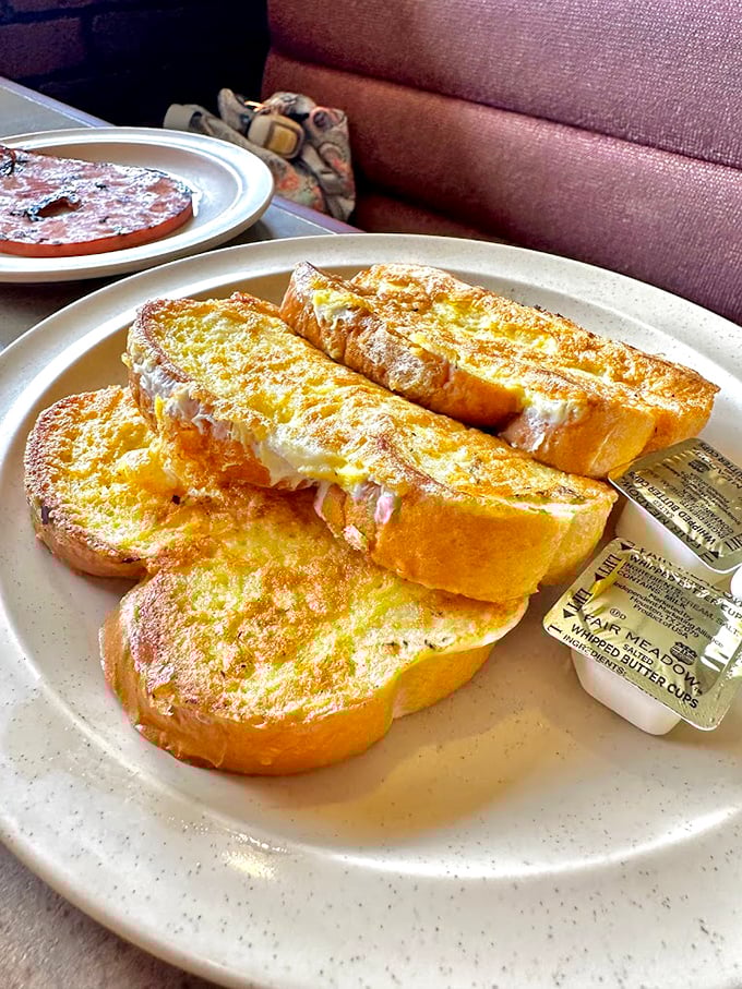 Golden French toast stacked high, ready for its maple syrup shower. Breakfast doesn't get more comforting than this buttery morning masterpiece.