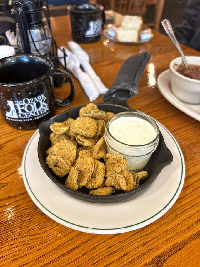 Fried pickles served in a cast-iron skillet—because in the Ozarks, even the serving dishes tell a story of tradition and timeless cooking methods.