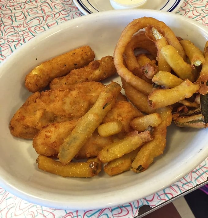 Golden-fried perfection on a plate – where onion rings, chicken tenders, and mozzarella sticks form a triumvirate of crispy indulgence.