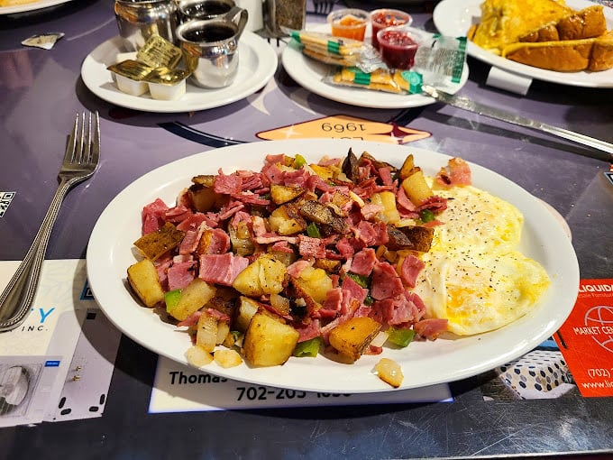 A mountain of home fries and ham that could fuel a desert hike or, more likely, a glorious food coma that makes you cancel all afternoon plans.