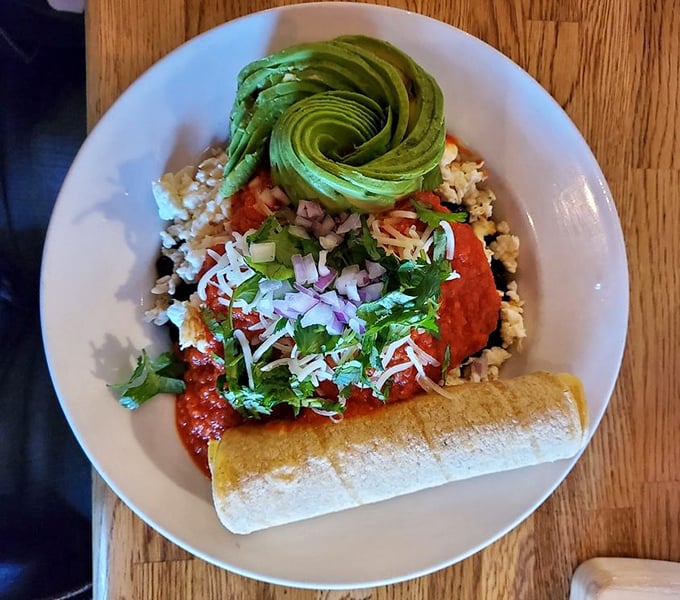 A beautiful rose of avocado crowns this Mexican-inspired masterpiece. It's not just breakfast – it's edible art with a kick.