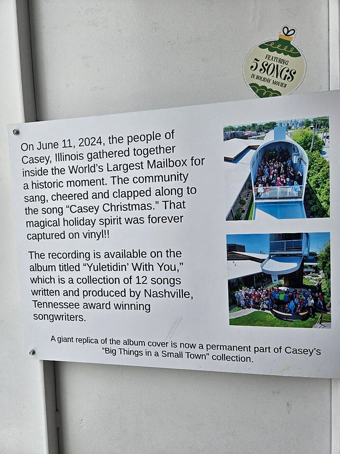 A plaque commemorates when Casey residents gathered inside to record "Casey Christmas," proving this mailbox delivers more than just letters—it creates community memories.