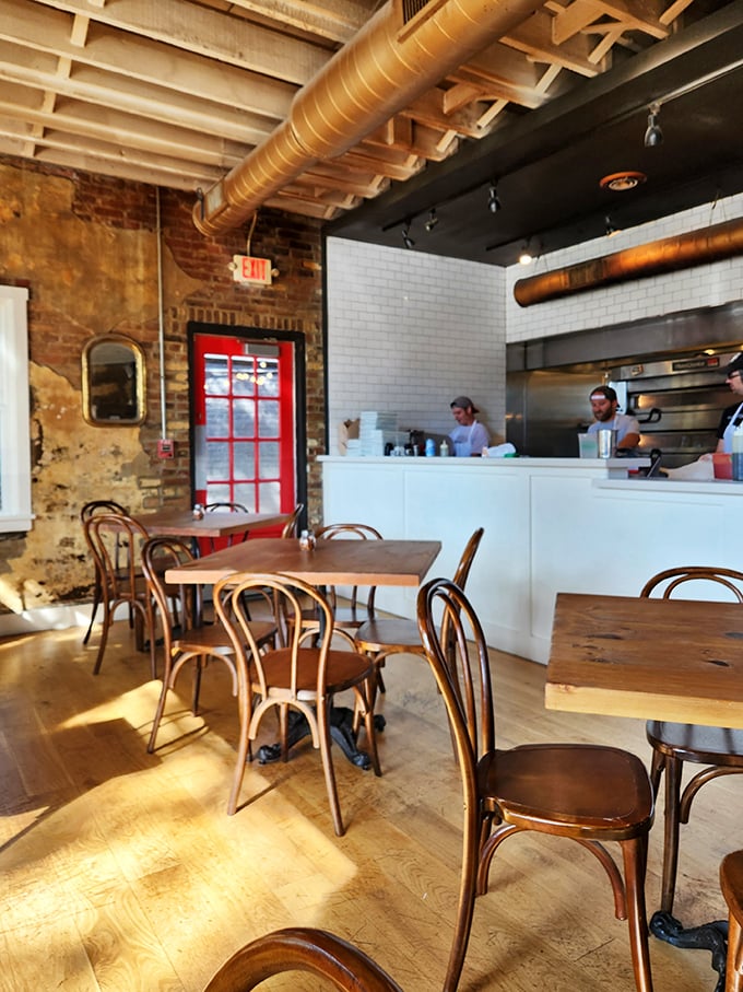 The open kitchen isn't just functional—it's dinner theater where dough-tossing becomes performance art and anticipation becomes an appetizer.
