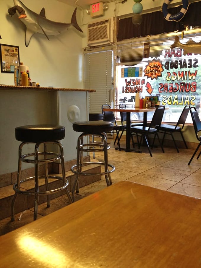 The shark on the wall has seen it all. This corner of Fish Shack offers the authentic Florida seafood joint atmosphere that fancy waterfront restaurants try to replicate.