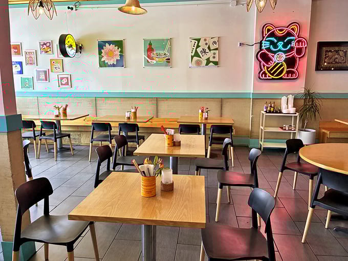 Clean, contemporary dining room with thoughtful touches—notice that neon lucky cat watching over diners like a delicious guardian angel.