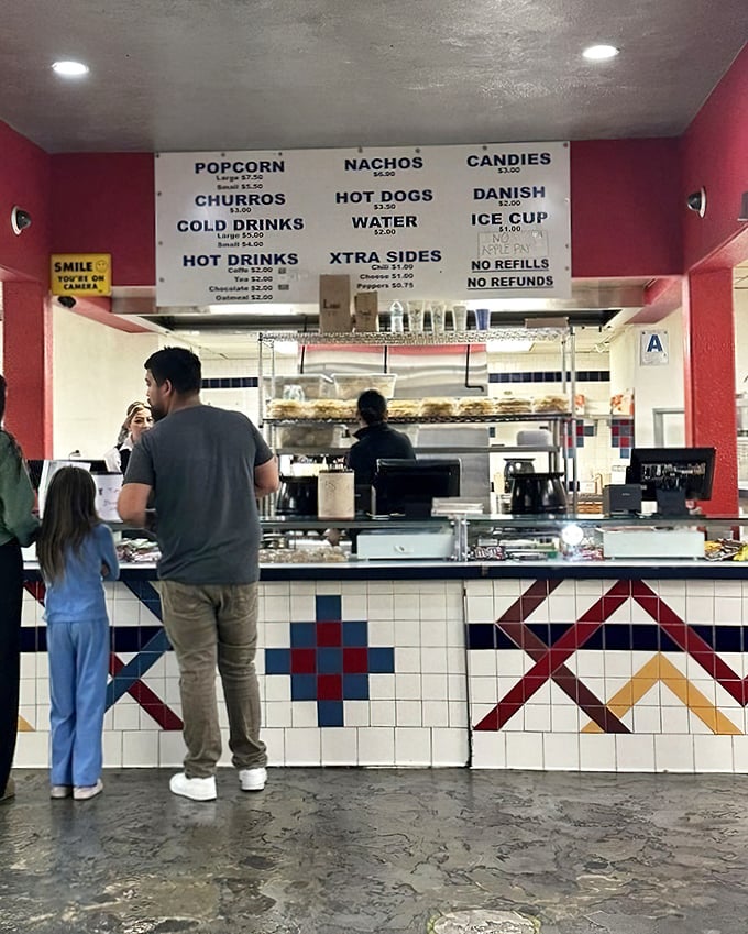 The concession stand—where movie theater classics meet unexpected delights. Those colorful tiles have witnessed decades of snack decisions.
