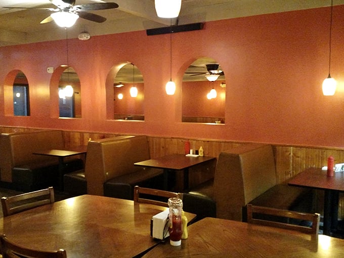 Cozy booths where food dreams come true. The arched windows and pendant lights create the perfect backdrop for serious eating business.