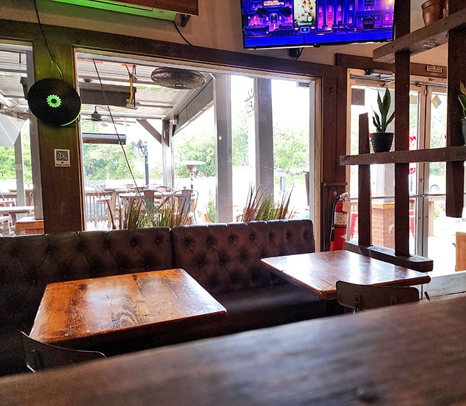 The leather booth seating and wooden tables create that rare dining sweet spot—casual enough for Tuesday, nice enough for date night.