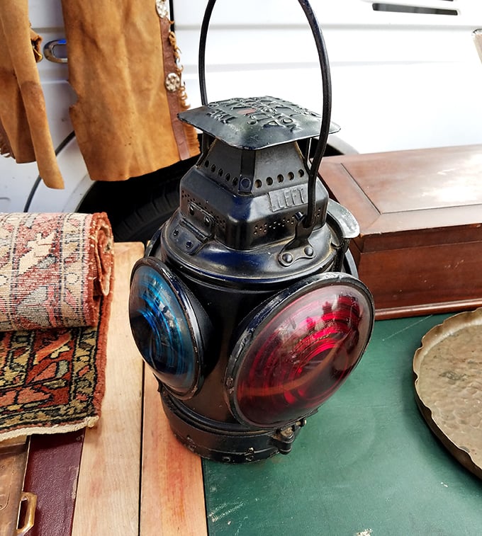 This vintage railroad lantern isn't just illumination—it's industrial art with red and blue lenses that could easily become your living room's conversation piece.