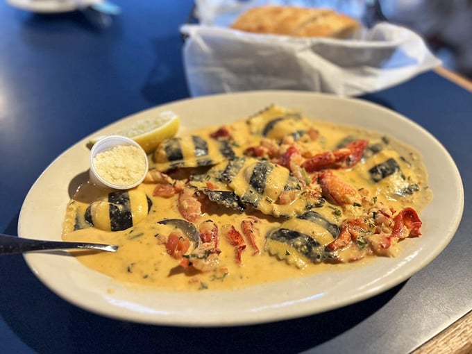 Pasta pillows swimming in a creamy sea, each one hiding treasures of lobster meat—like underwater presents waiting to be unwrapped.
