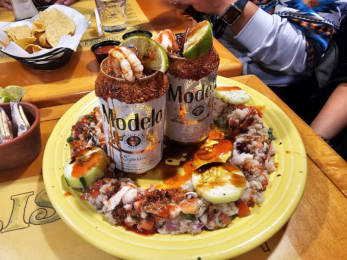 Beer-based micheladas served with a seafood garnish—because sometimes your drink deserves its own appetizer.