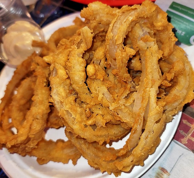 Onion rings that redefine the category—hand-cut, hand-battered jumbo beauties with a crunch you can hear across the restaurant.