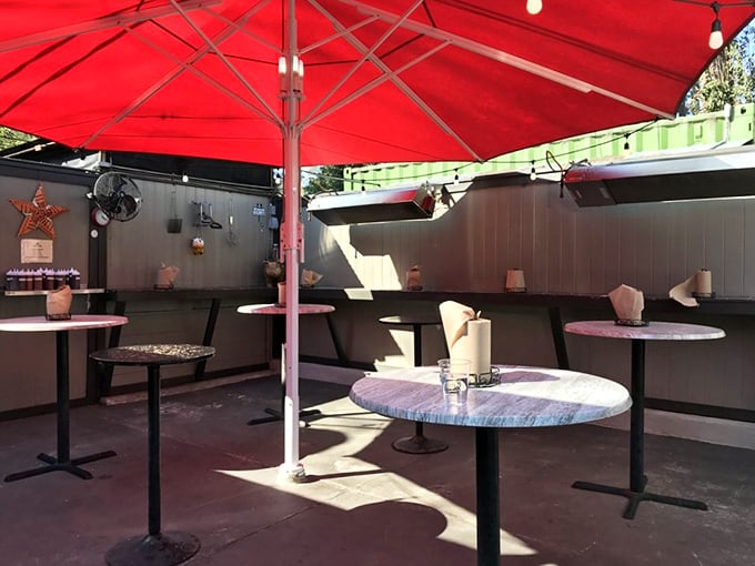 The outdoor dining area—where strangers become friends united by the universal language of "mmm" and "have you tried the brisket yet?"