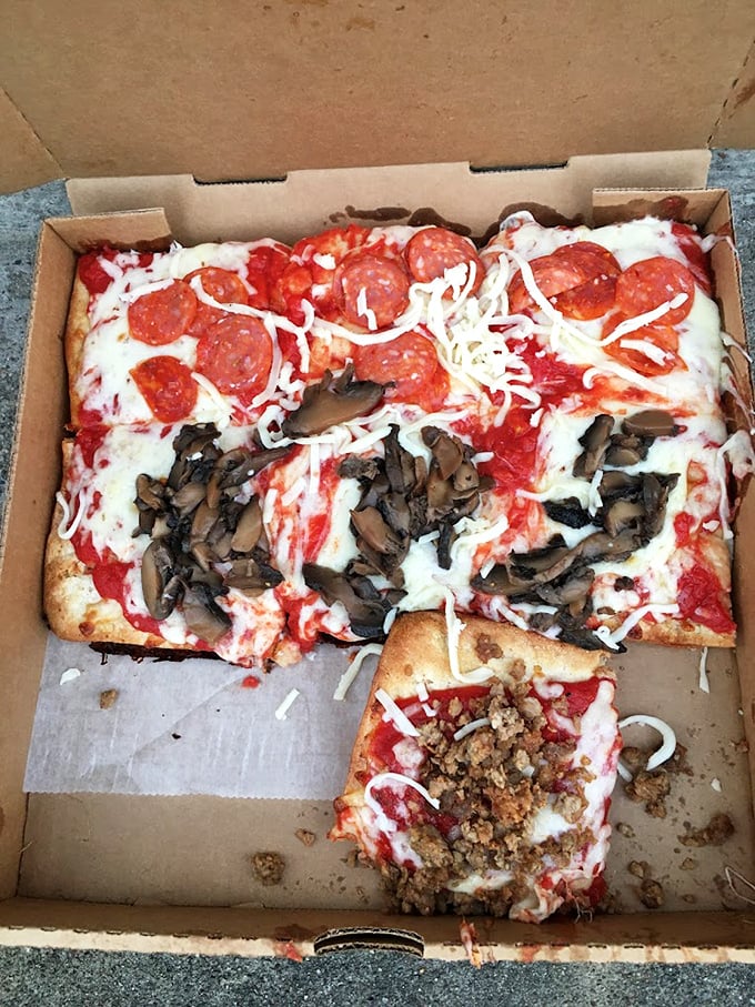 The holy trinity of pizza toppings—pepperoni, mushrooms, and sausage—living harmoniously on one magnificent slice. Pizza diplomacy at its finest.