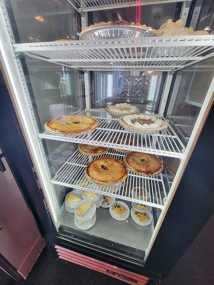 The pie case – Nebraska's version of the Louvre. Each shelf displays edible masterpieces that have brought joy to generations of dessert enthusiasts.