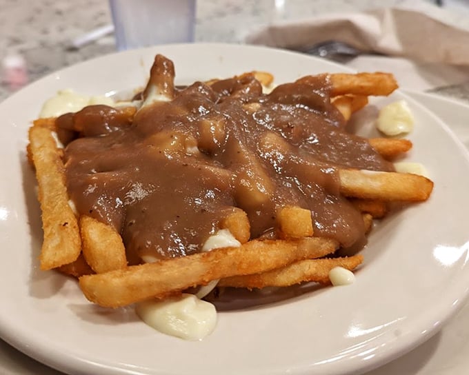 Poutine that would make Canadians nod in approval – a glorious mess of fries, gravy, and cheese that demands to be devoured.