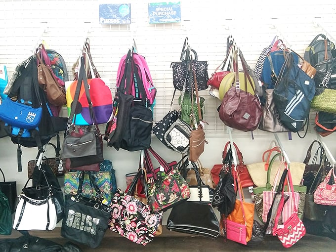The handbag wall—a kaleidoscope of colors and textures. Each one previously carried someone's essentials and secrets.
