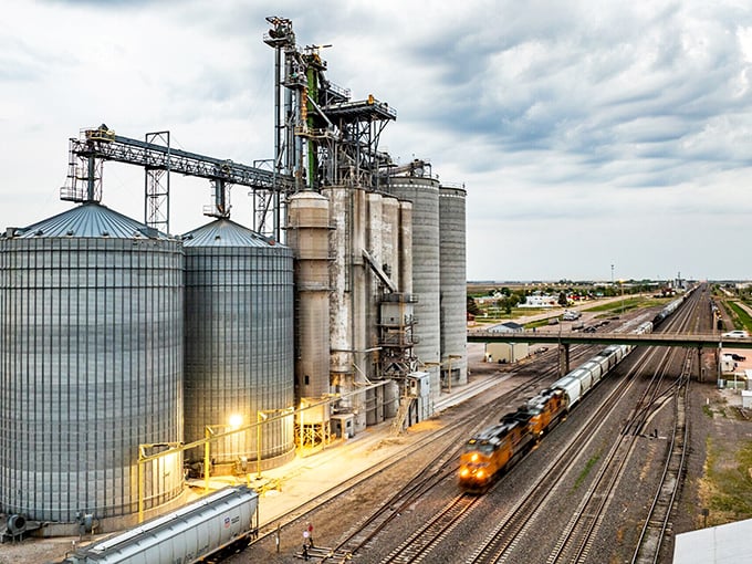 Where agriculture meets transportation in a symphony of American industry. Those grain elevators aren't just storage—they're cathedrals to corn.