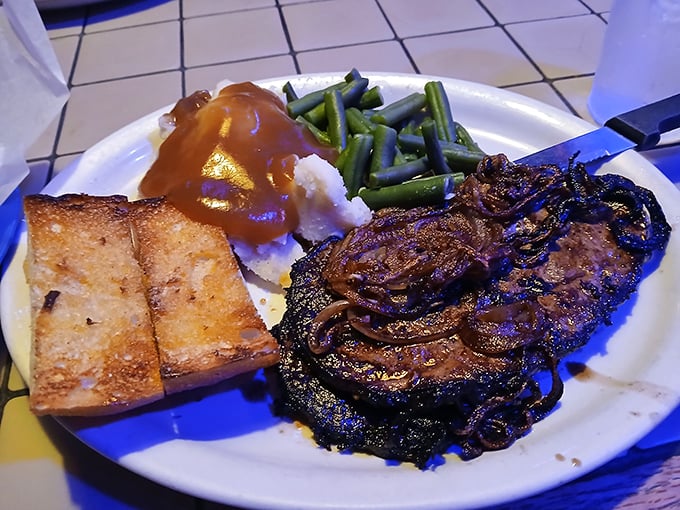 This isn't just dinner—it's a commitment. A steak that's been properly caramelized, green beans that haven't been forgotten, and garlic bread ready to soak up every last drop of gravy.