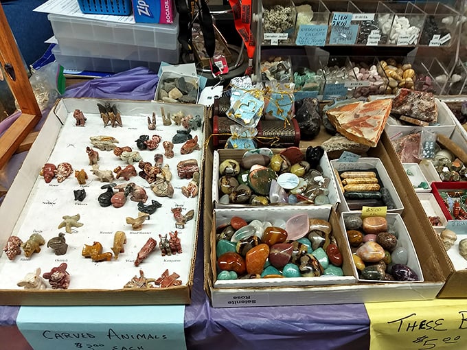 Carved animals and polished stones share table space – nature's art and human craftsmanship meeting at the crossroads of collectibility.