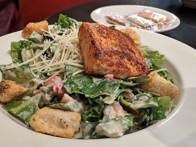 A Caesar salad that Julius himself would approve of, topped with salmon that clearly took the scenic route from the Gulf.